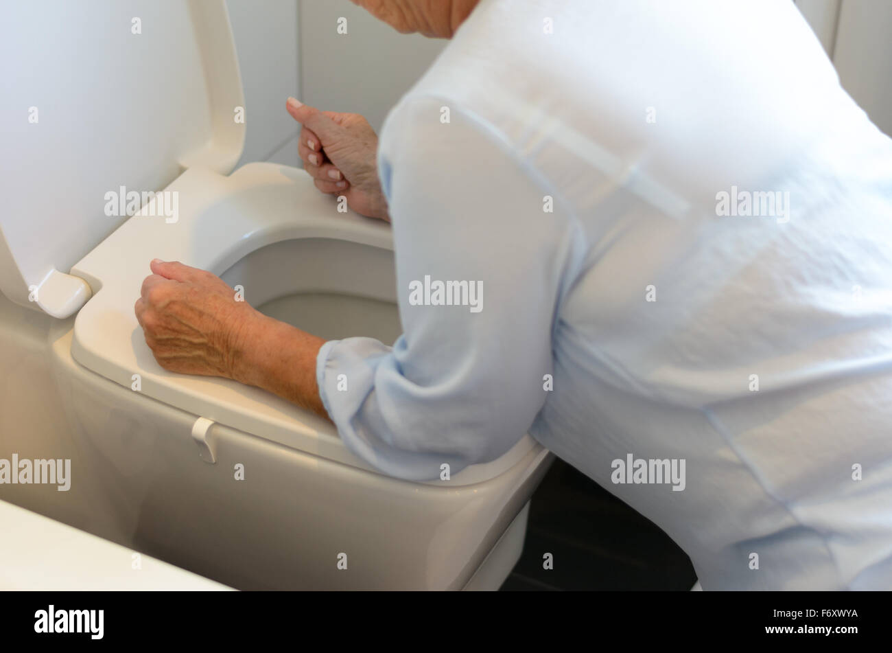 Woman vomiting into toilet hi-res stock photography and images - Alamy