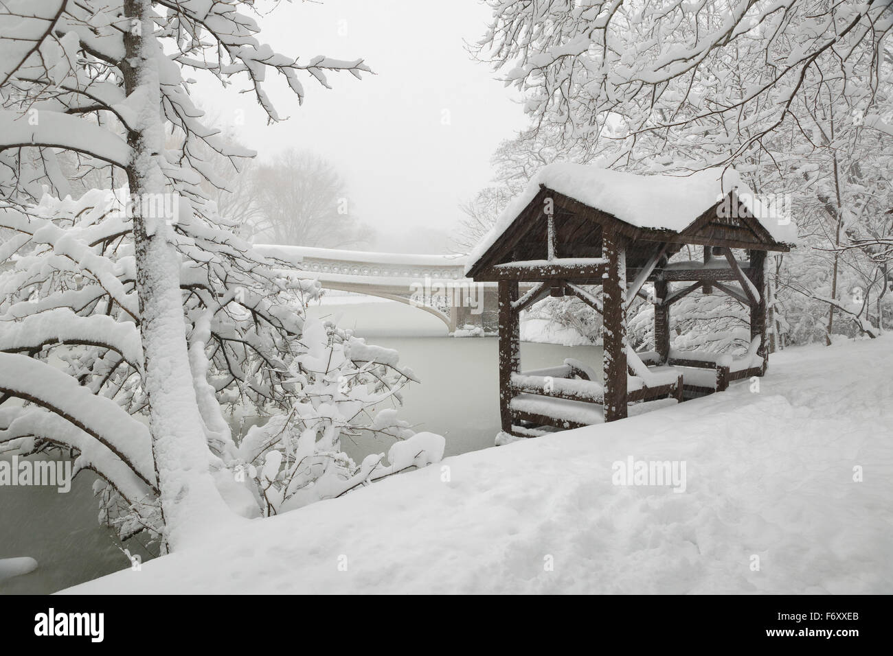 Central Park peaceful winter scene after heavy snowfall. The Bow Bridge ...