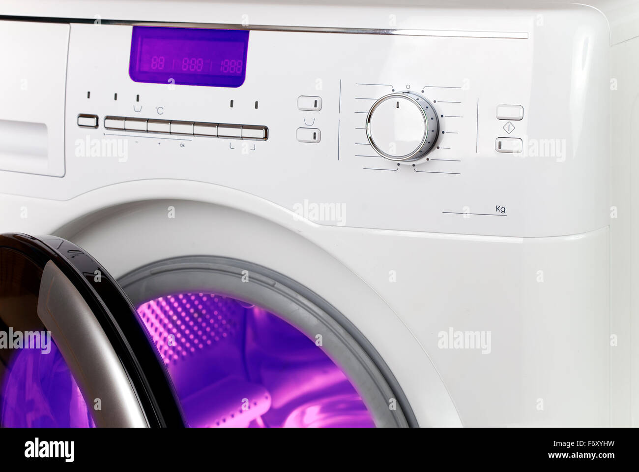 The washing machine - a close up of the display, the manhole and a ...