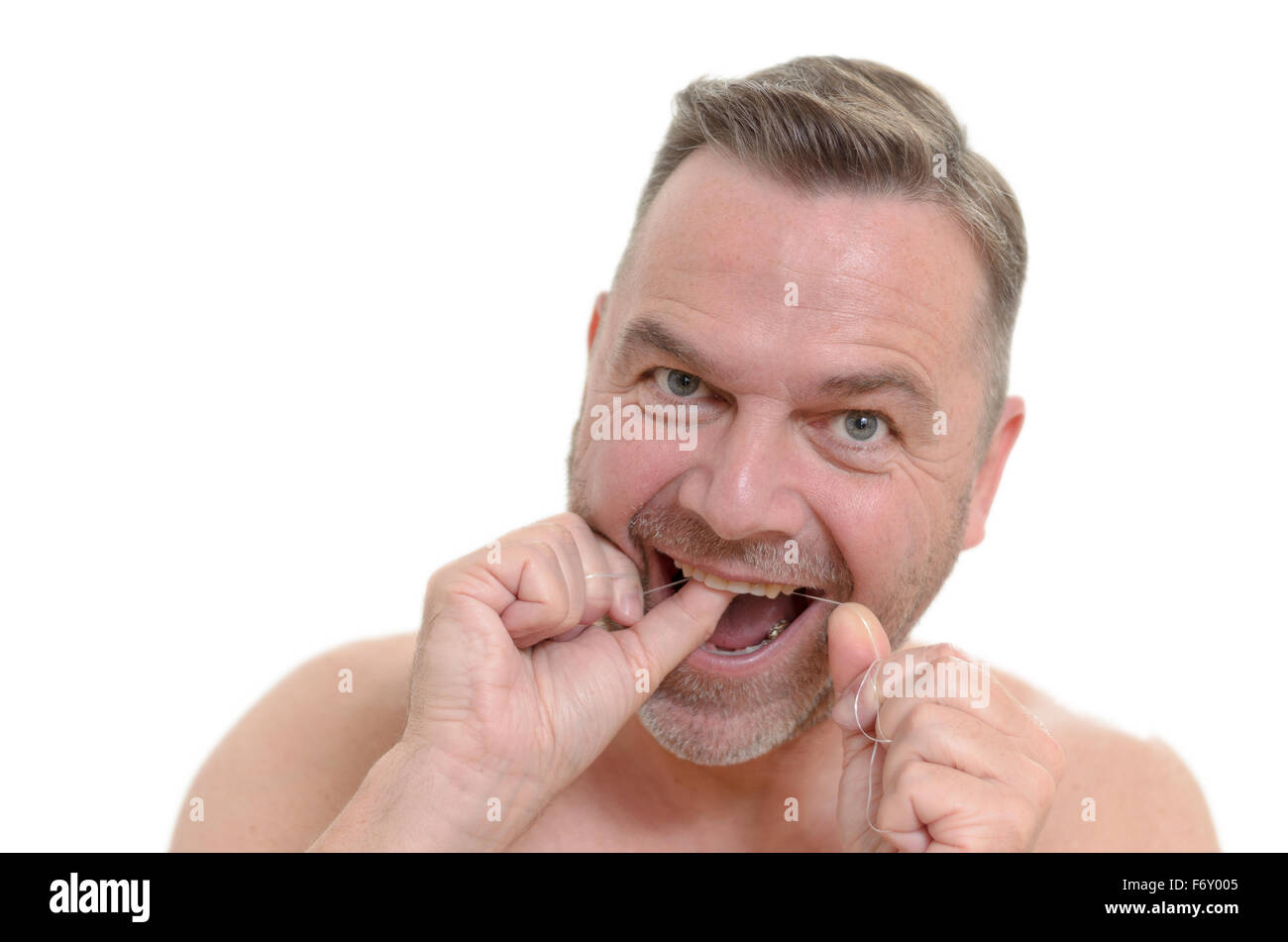 Man flossing between his teeth with dental floss to prevent plaque ...