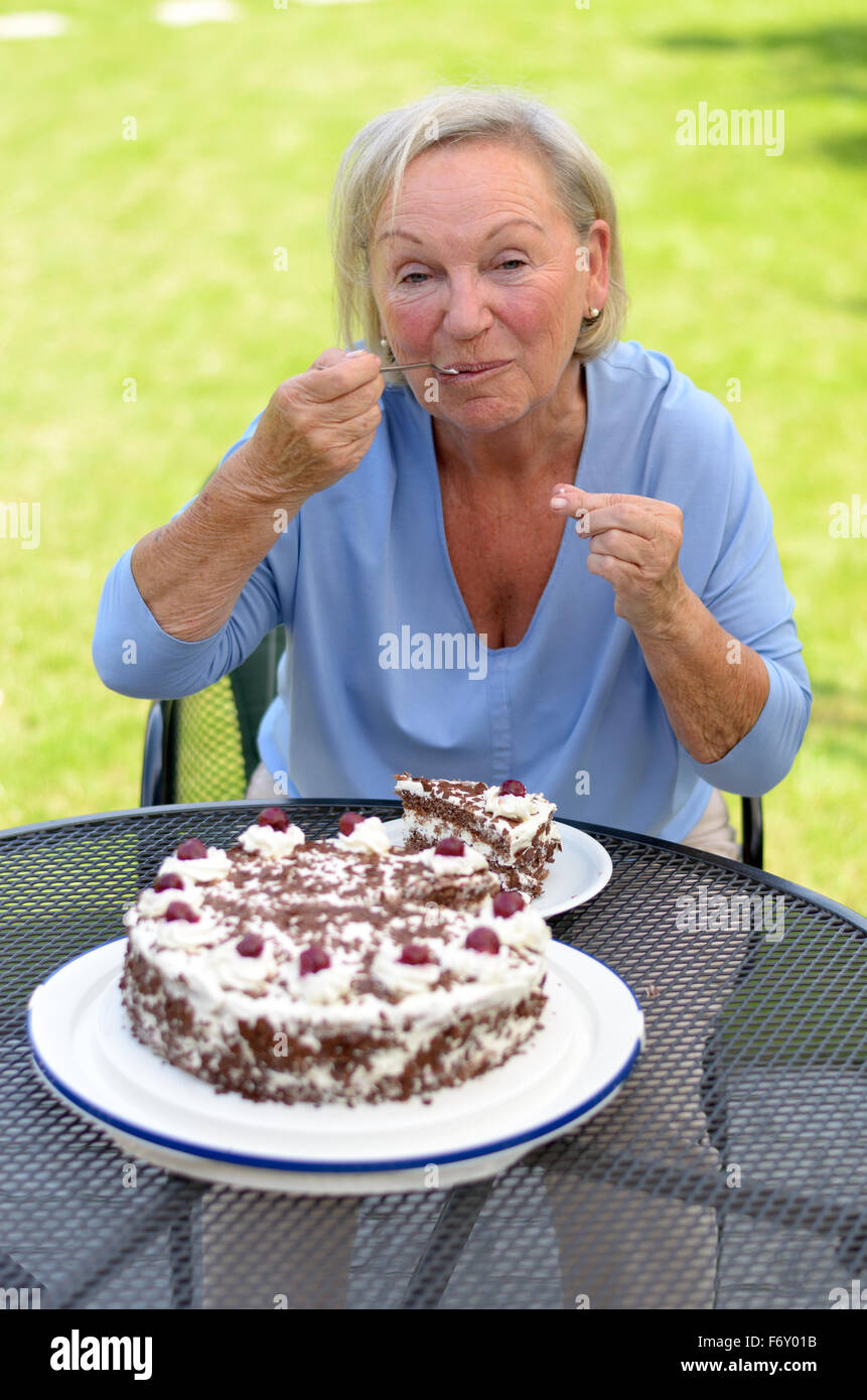Elderly woman eating chocolate hi-res stock photography and images - Alamy