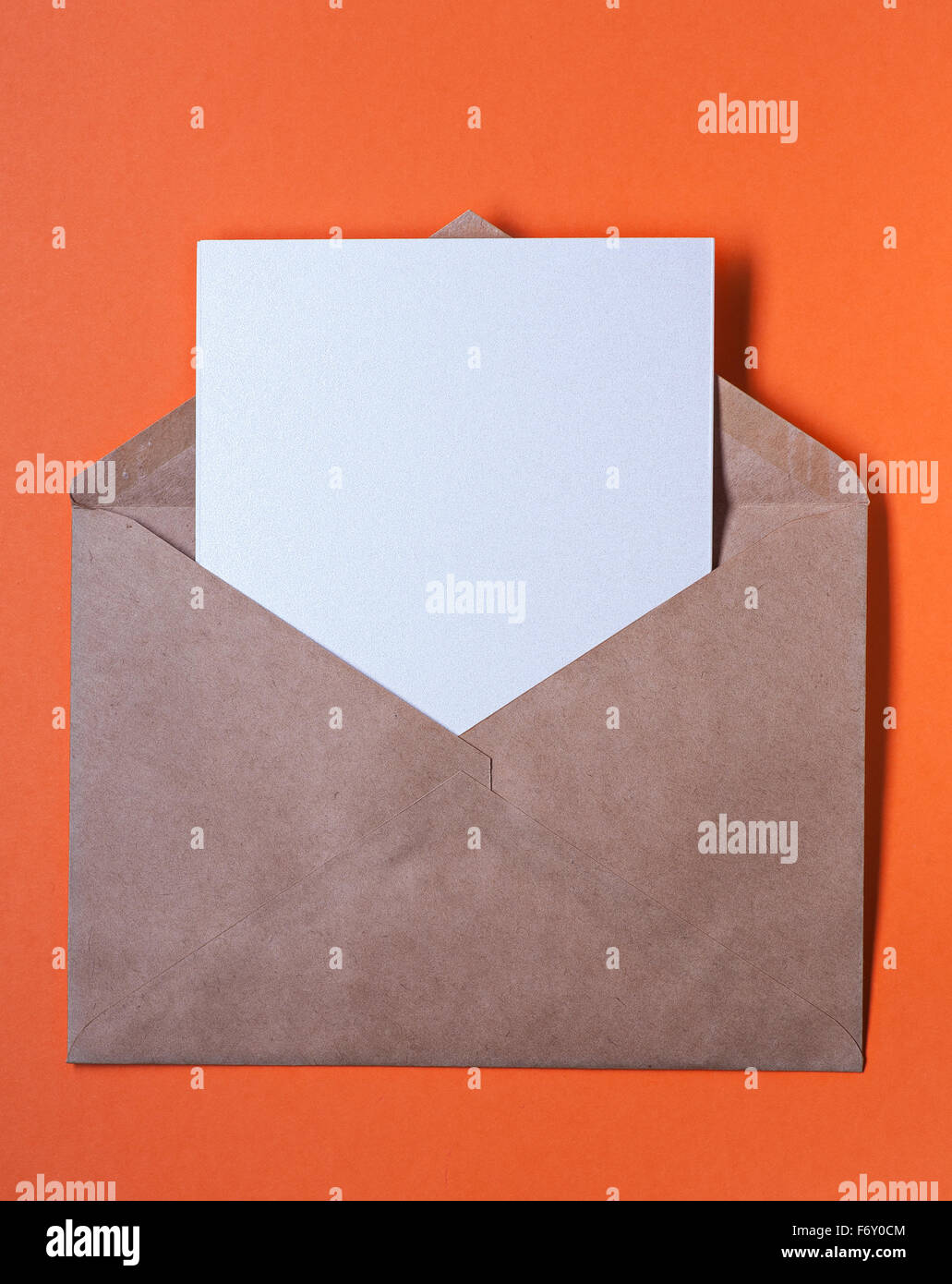 Brown paper envelop with blank letter inside on orange background Stock ...