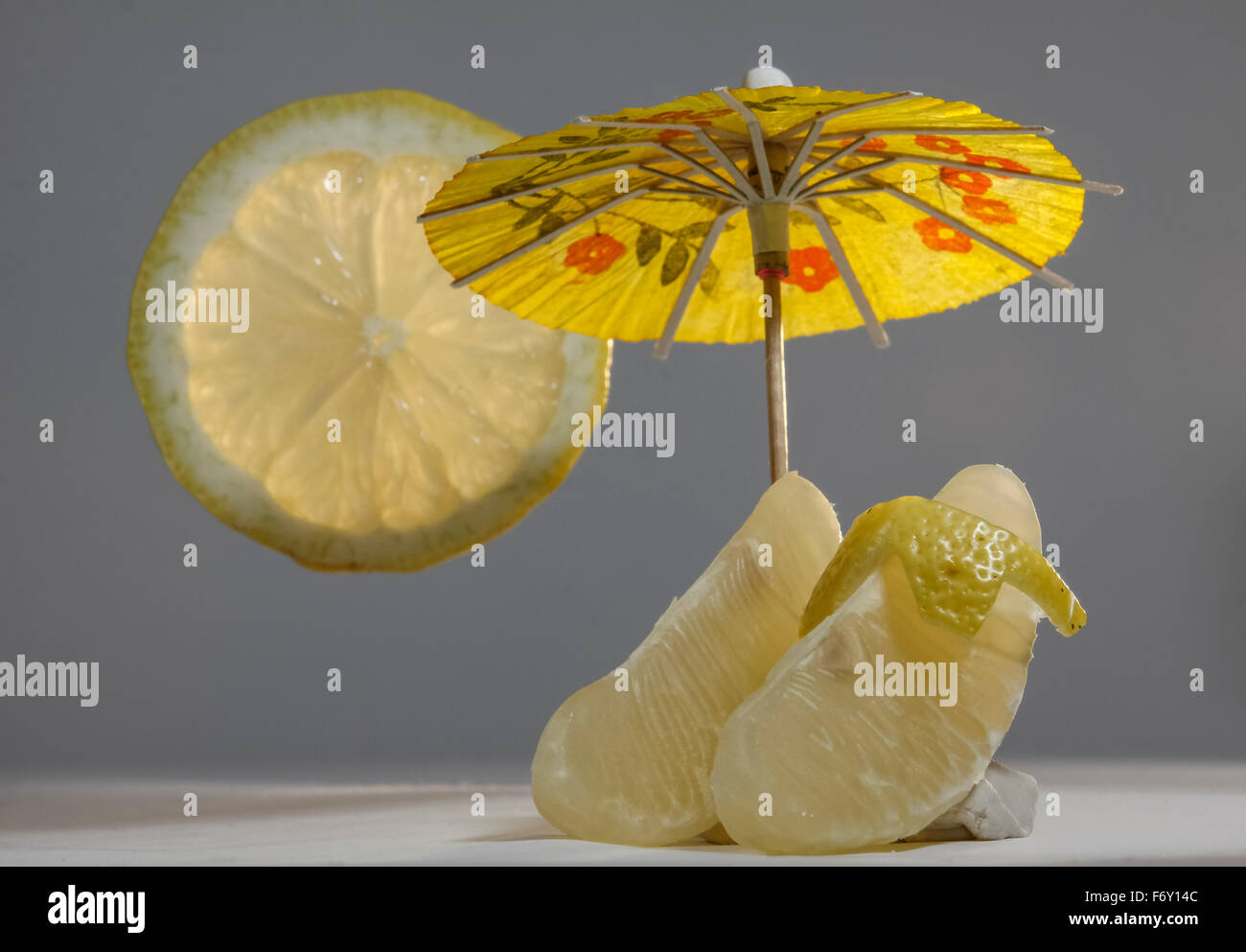 two pieces of lemon under the sun umbrella Stock Photo - Alamy