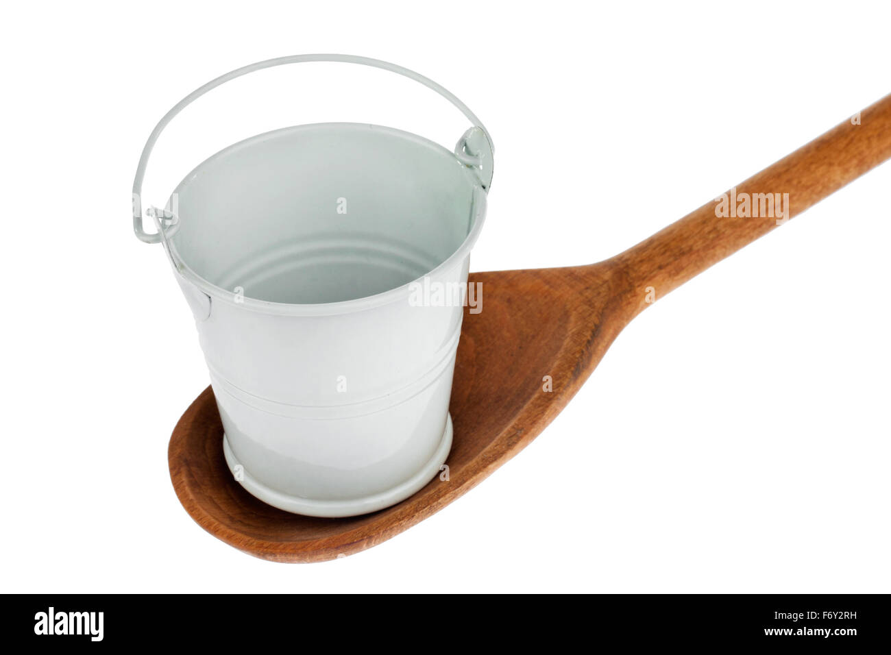 Bucket is in a wooden spoon, concept Stock Photo - Alamy