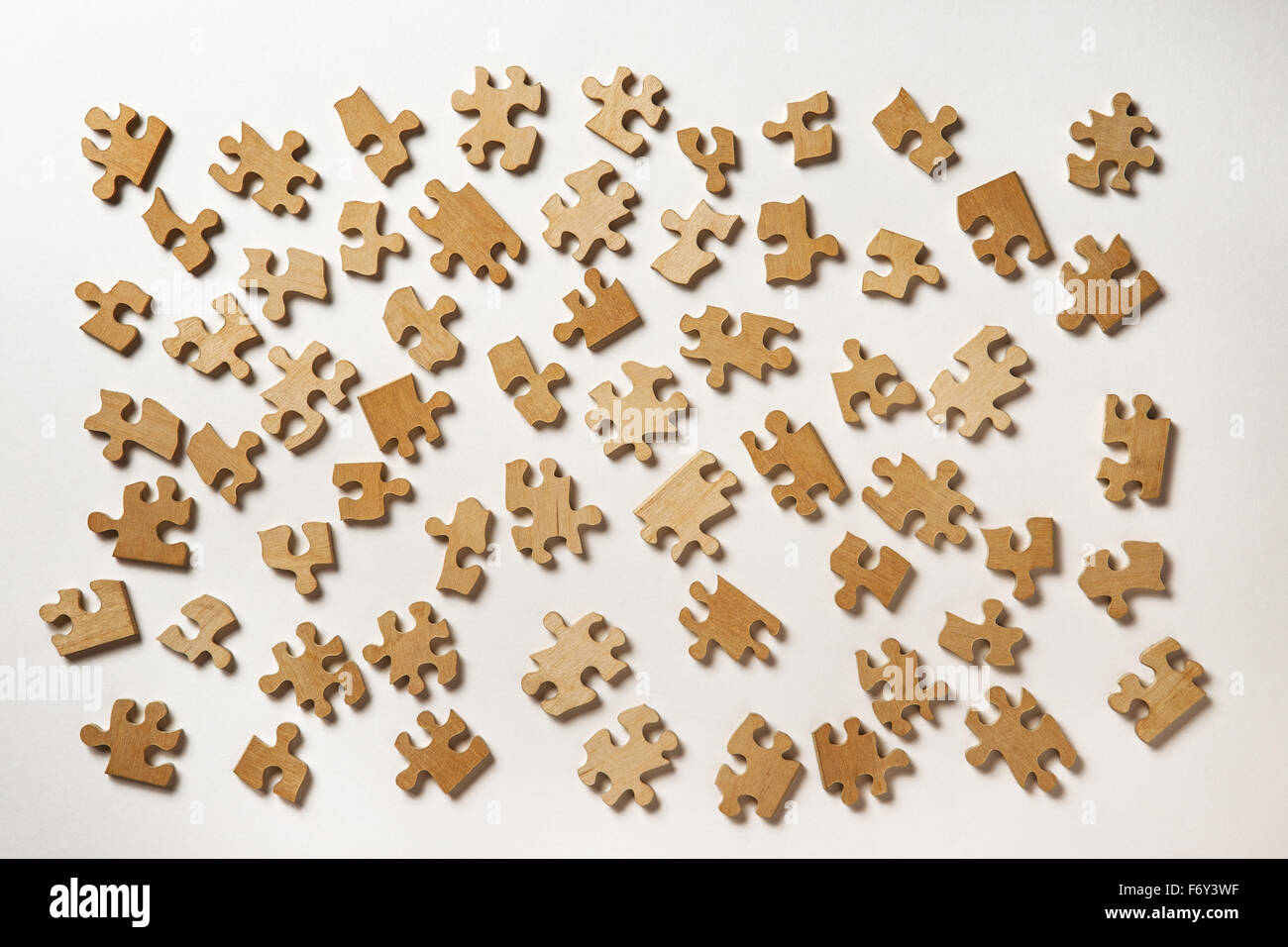 old plain wooden jigsaw pieces laid out on a white background Stock ...