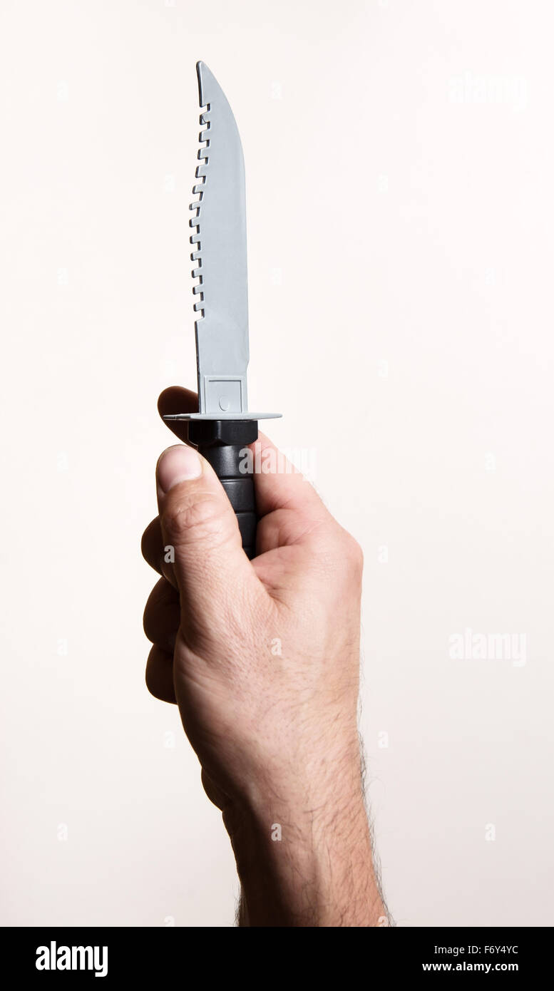 man's hand holding a plastic toy hunting knife Stock Photo - Alamy