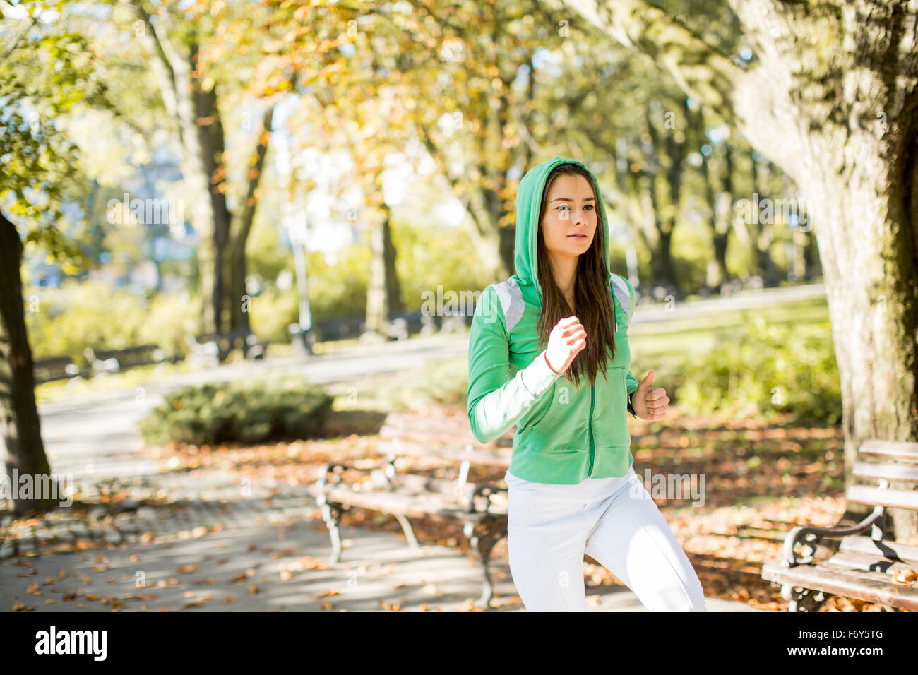 Young woman running in the park Stock Photo - Alamy