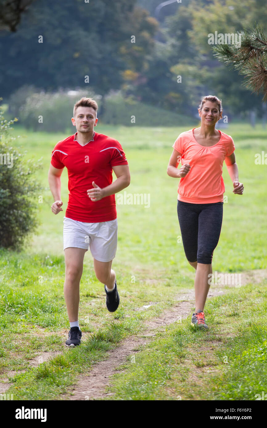 Young people running in the park Stock Photo - Alamy