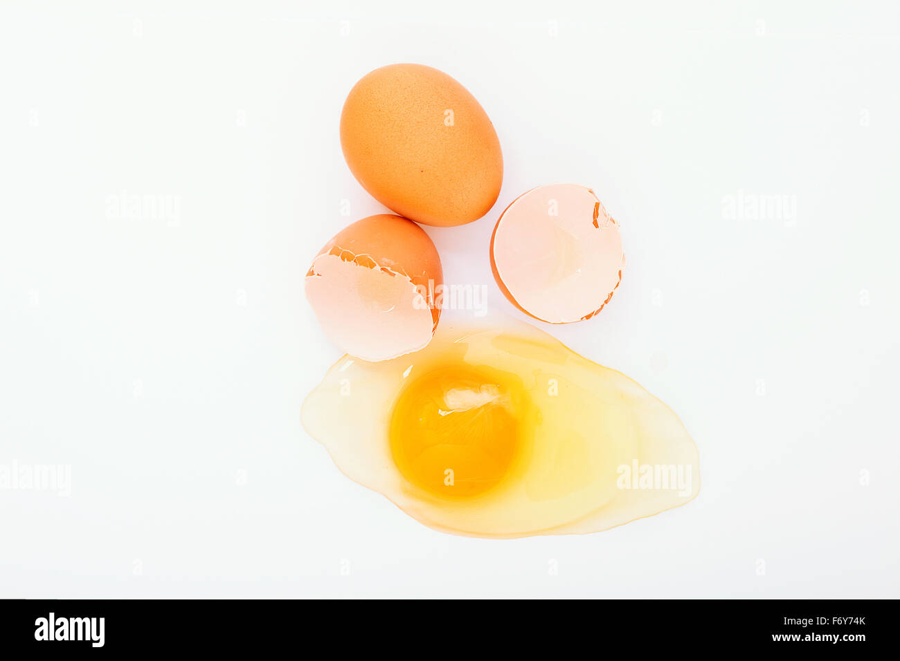 Broken egg on white background Stock Photo - Alamy