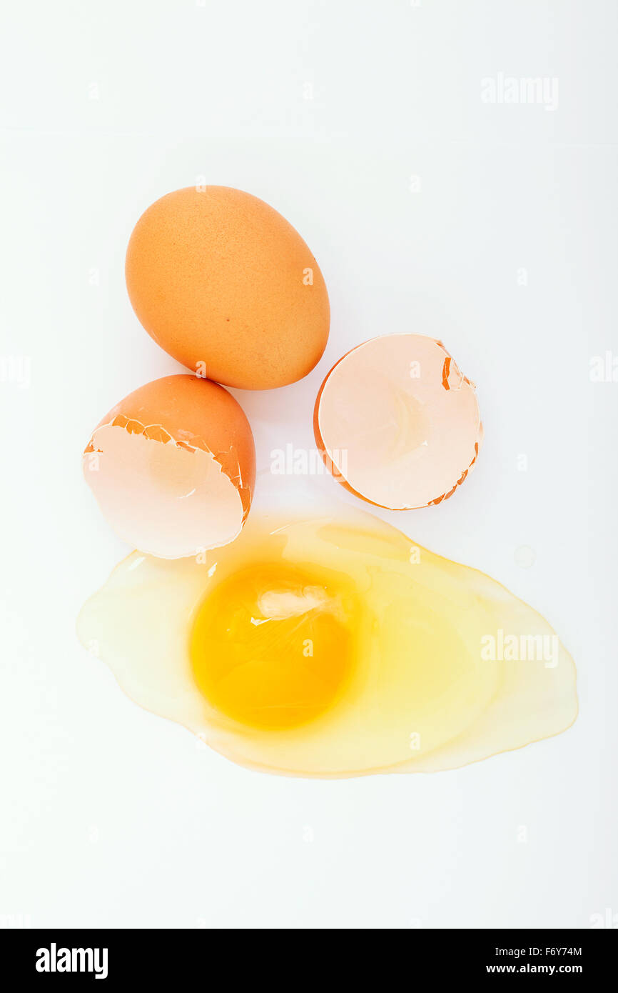 Broken egg on white background Stock Photo - Alamy