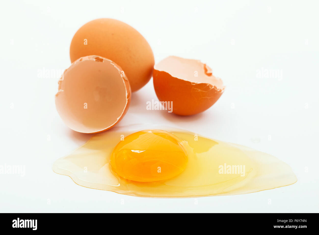 Broken egg on white background Stock Photo - Alamy