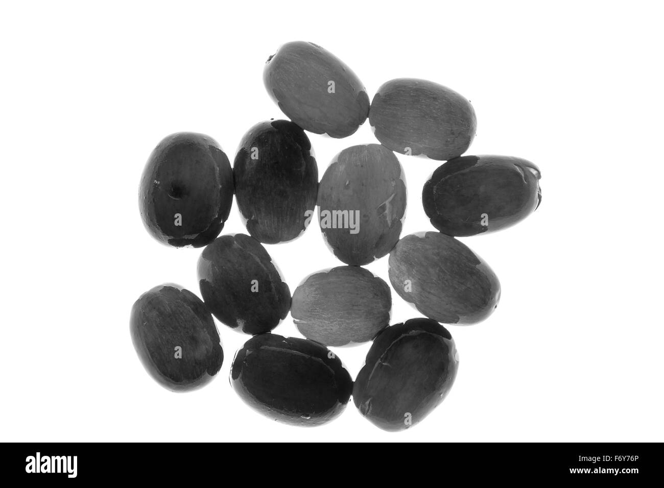 red grape pieces, cut out shot on white background lit from bellow ...
