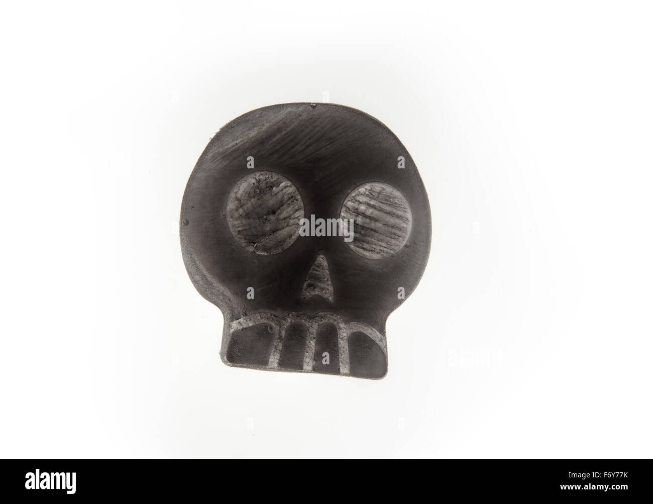 Ice Cube in the shape of a human skull melting on a white background ...