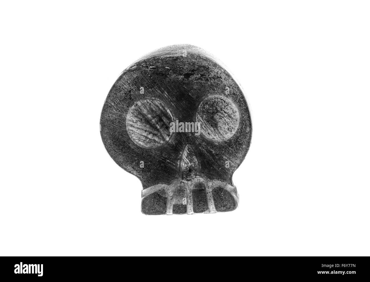 Ice Cube in the shape of a human skull melting on a white background ...