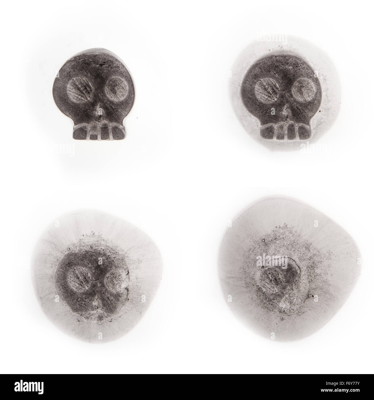 Ice Cube in the shape of a human skull melting on a white background ...