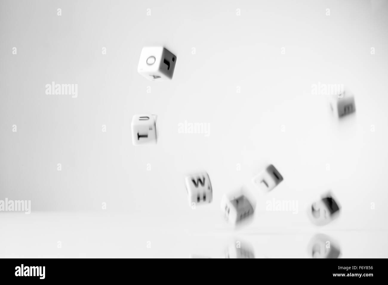 still life image of letter dice falling from the sky Stock Photo - Alamy
