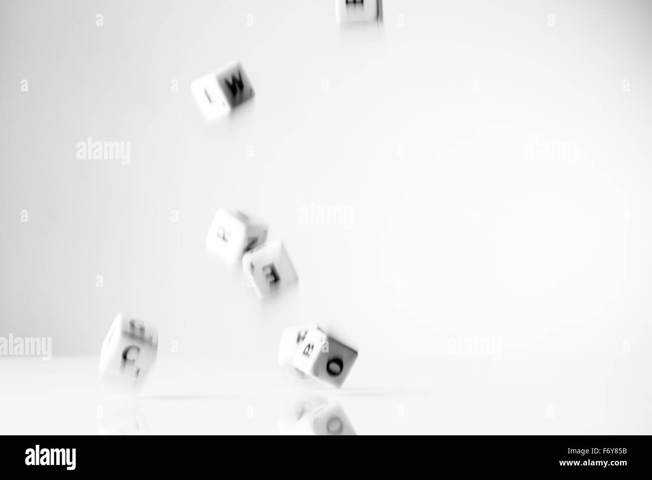 still life image of letter dice falling from the sky Stock Photo - Alamy