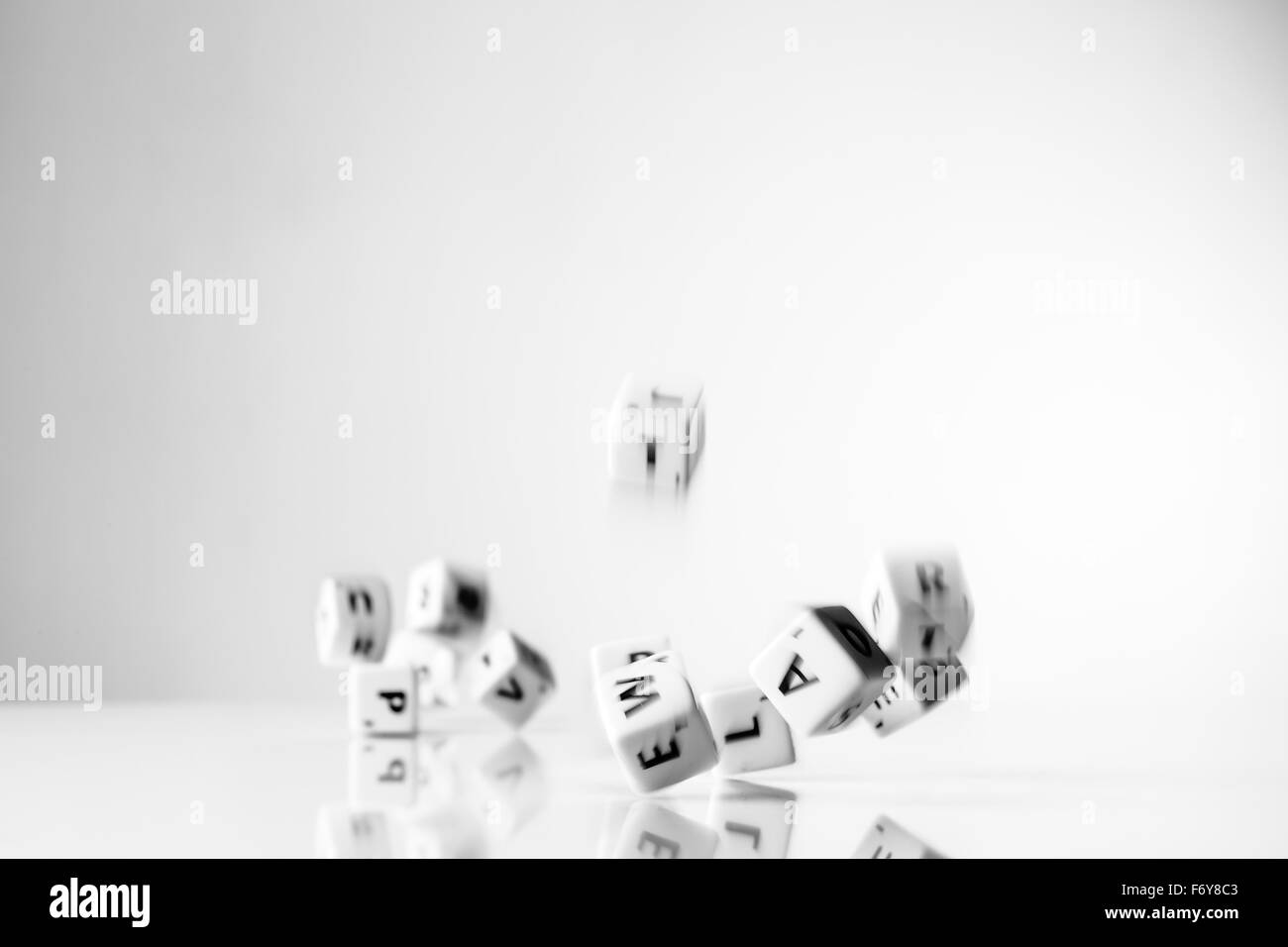 still life image of letter dice falling from the sky Stock Photo - Alamy
