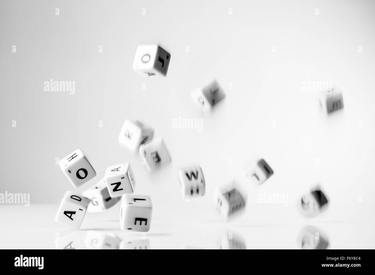 still life image of letter dice falling from the sky Stock Photo - Alamy