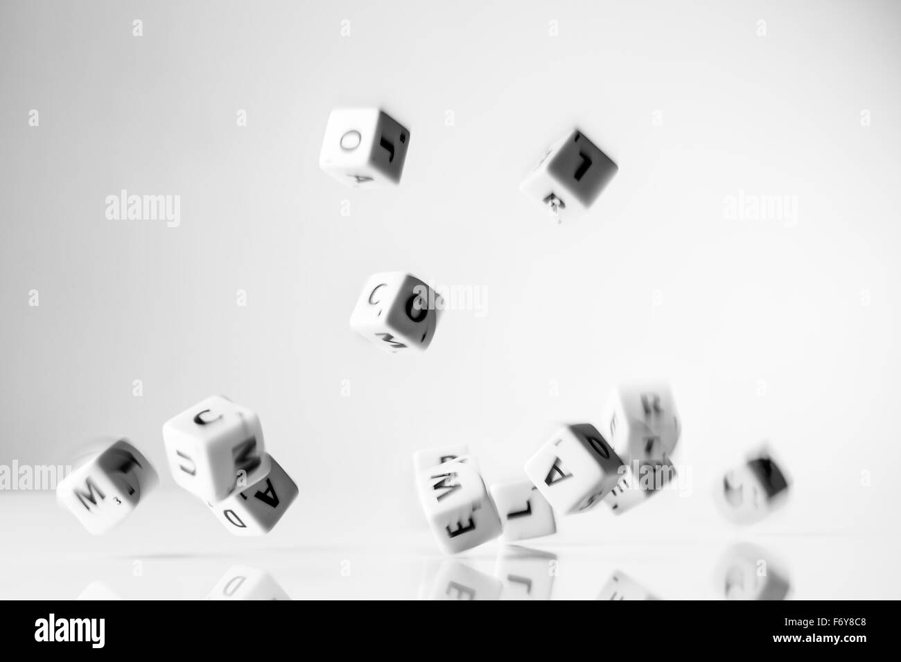still life image of letter dice falling from the sky Stock Photo - Alamy