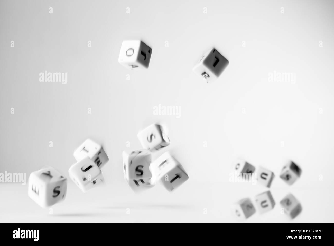 still life image of letter dice falling from the sky Stock Photo - Alamy