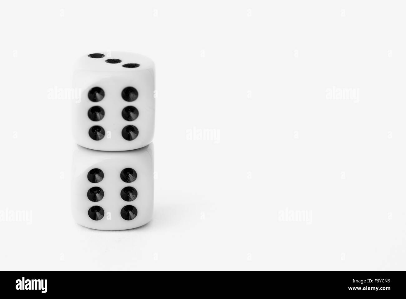 Stack of two die with both showing the six face Stock Photo - Alamy