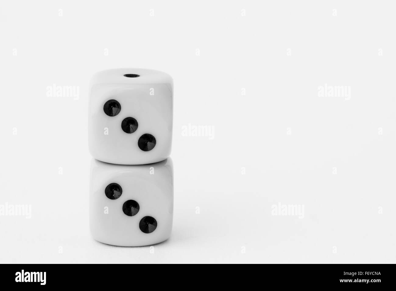 Two dice stack Black and White Stock Photos & Images - Alamy