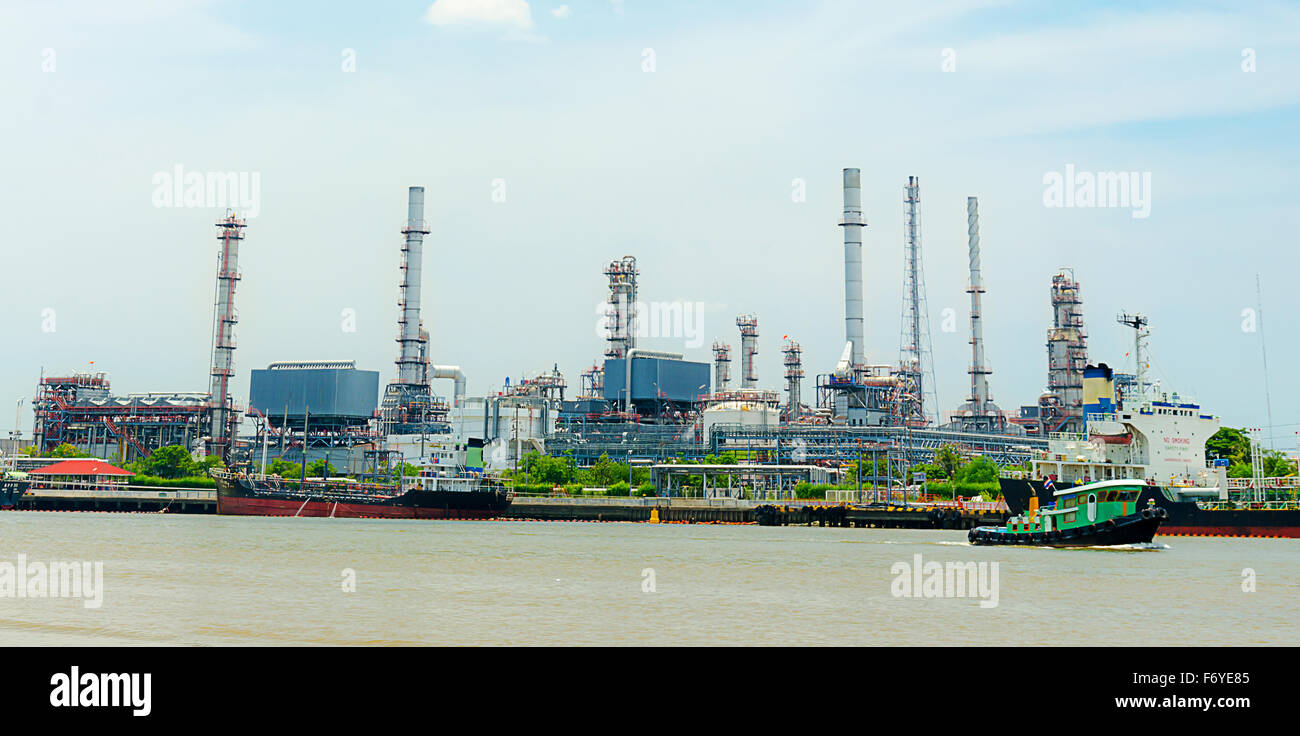 Oil refinery reflected on river. Panoramic images Stock Photo - Alamy