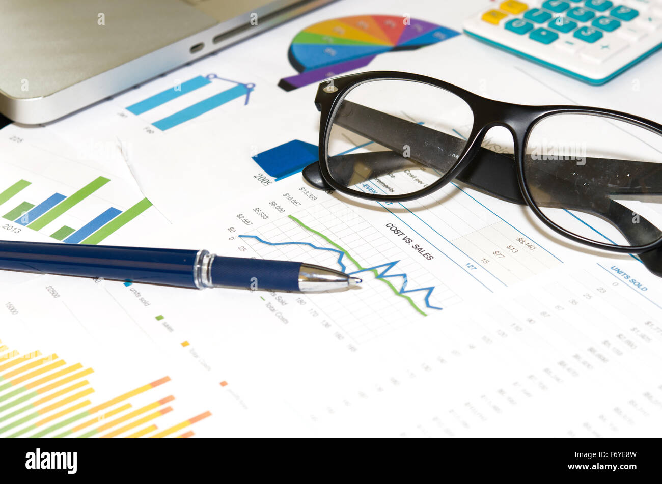 Financial graphs analysis and pen Stock Photo - Alamy
