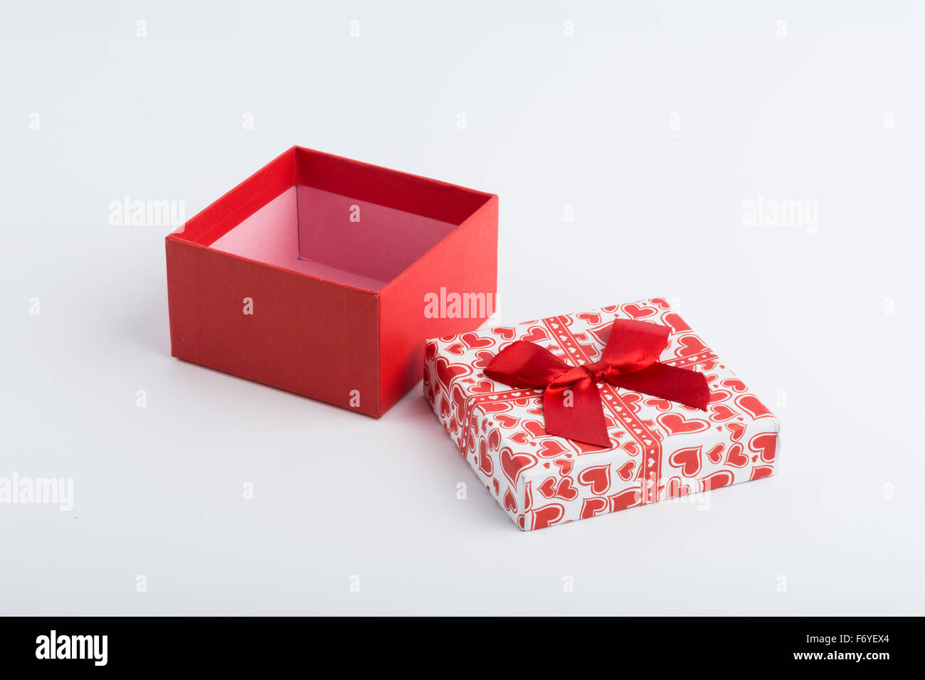 Red gift box now open on white background Stock Photo - Alamy