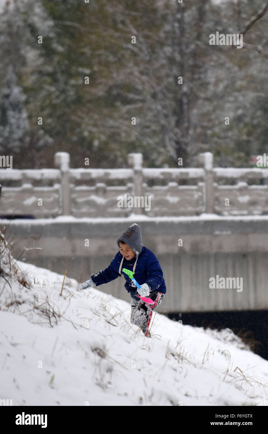Beijing, China. 22nd Nov, 2015. A boy enjoys snow fun at the River Park ...