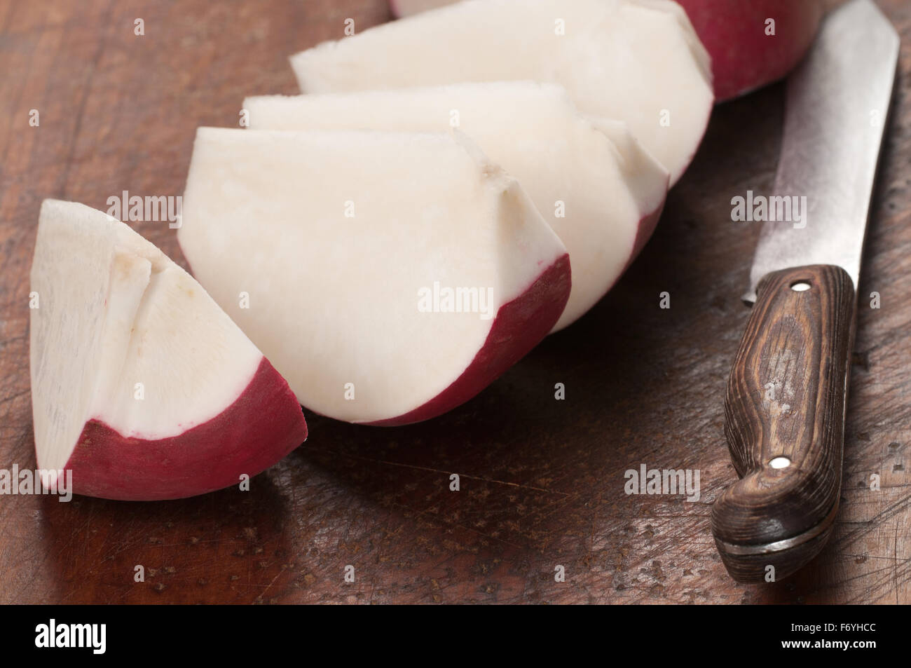 Radish cuts on a timber board, close up Stock Photo - Alamy