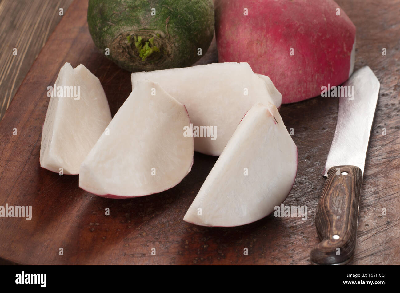 Radish cuts on a timber board, close up Stock Photo - Alamy