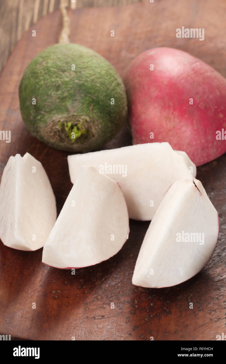Radish cuts on a timber board, close up Stock Photo - Alamy