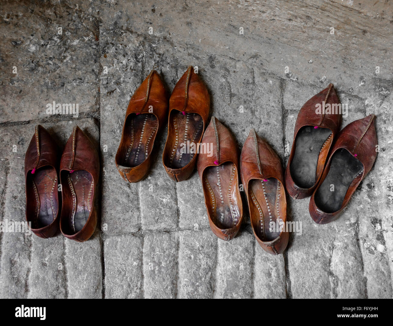 Four pairs of traditional Rajasthani footwear ( jooti ) kept on ground ...