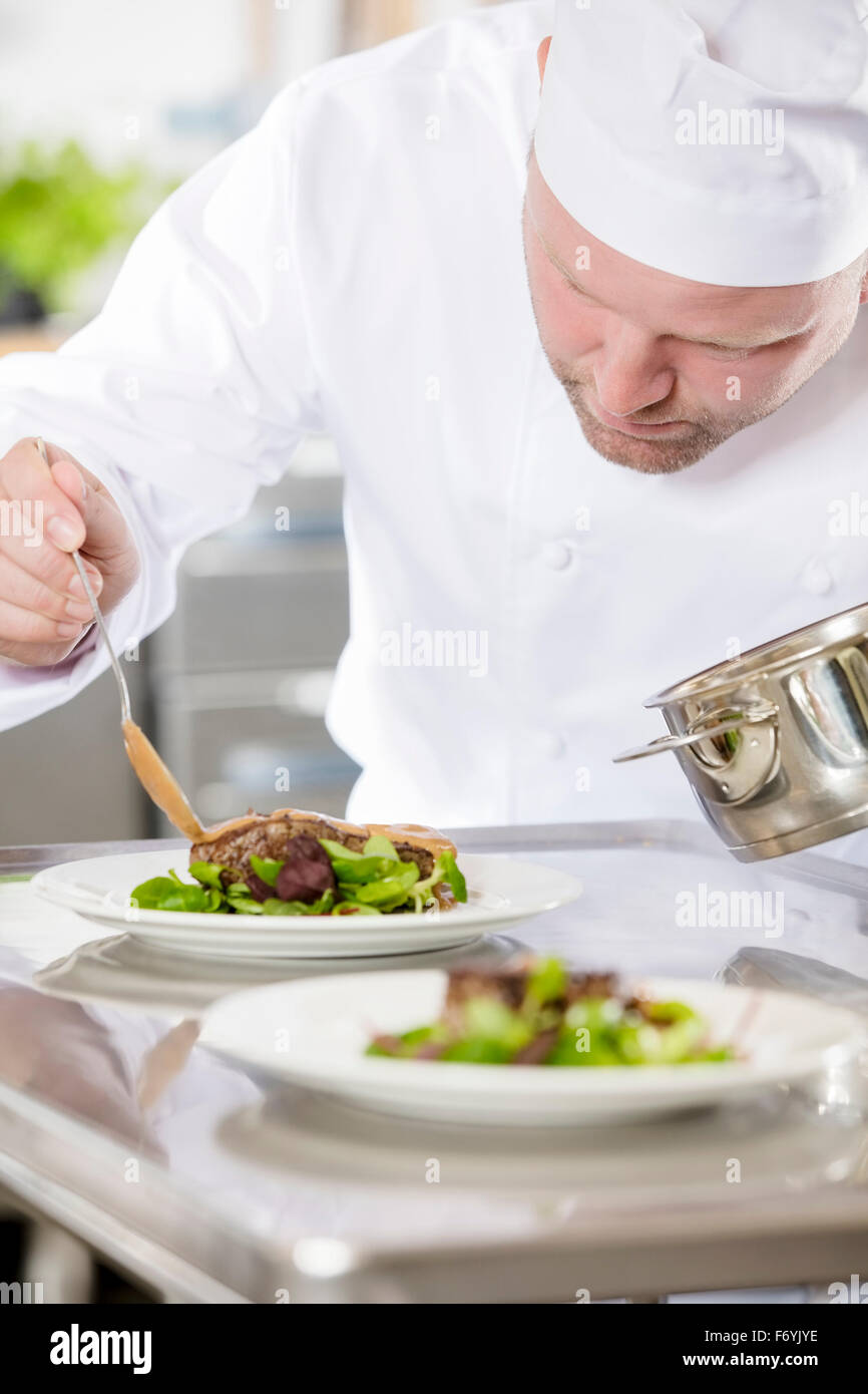 Professional chef prepare meat dish at restaurant Stock Photo - Alamy