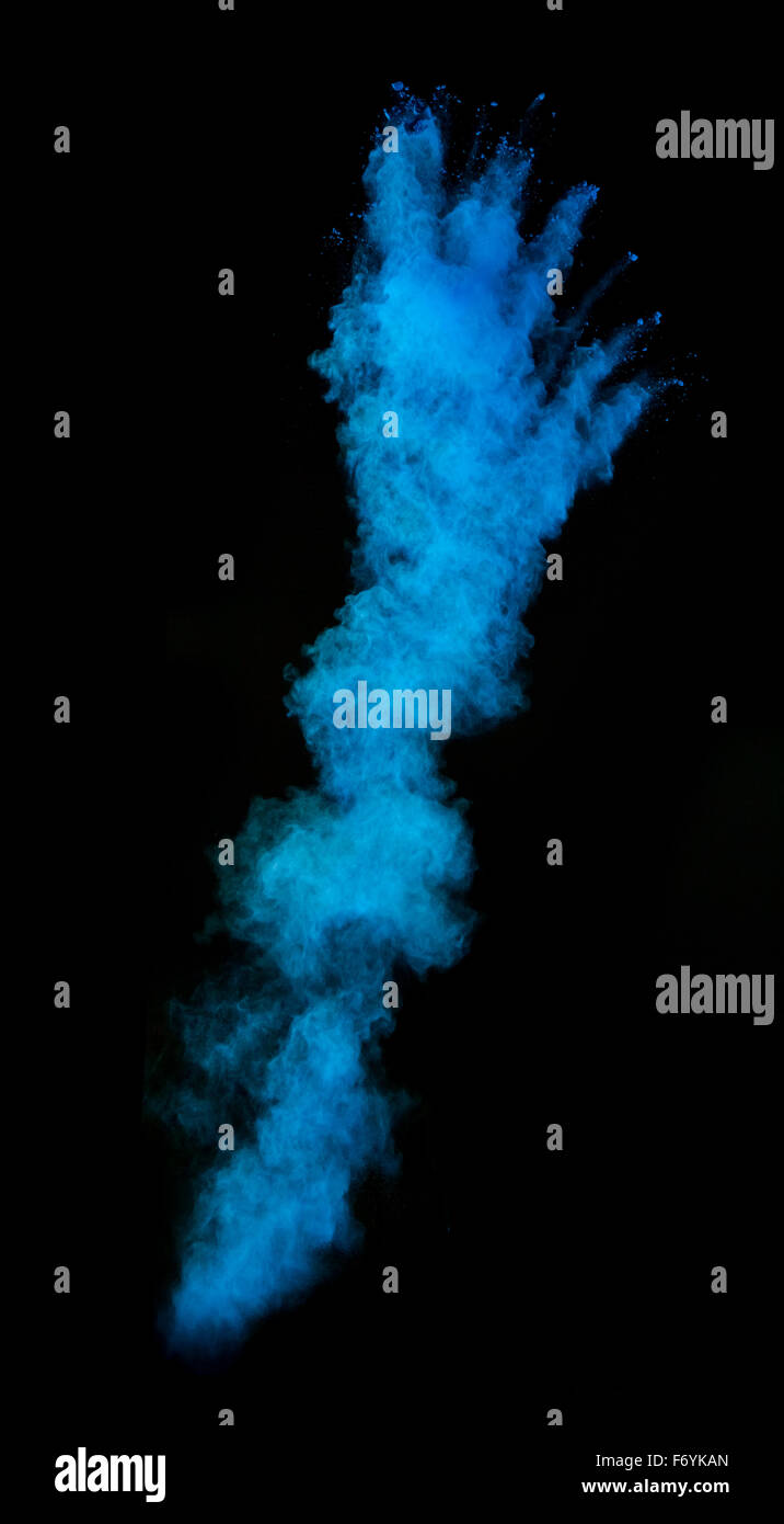 Freeze motion of blue dust explosion on black background Stock Photo ...