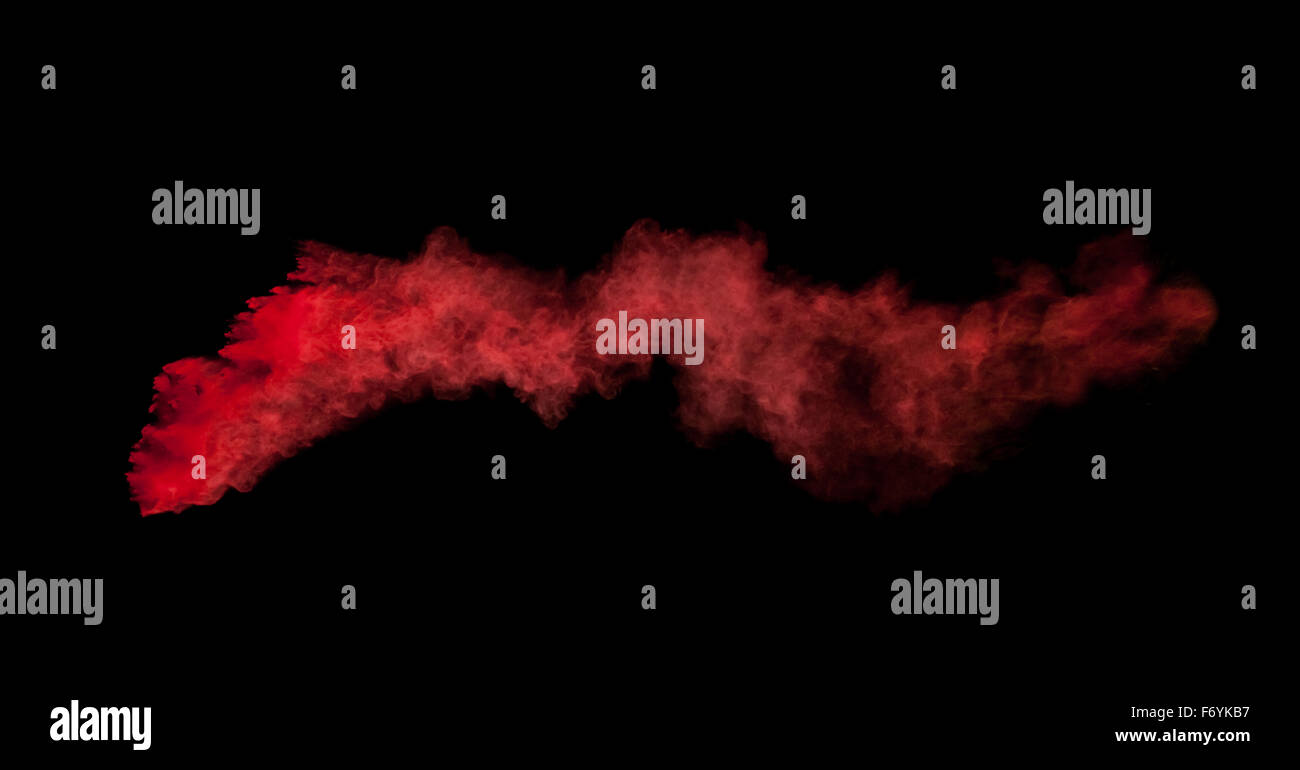 Freeze motion of red dust explosion on black background Stock Photo - Alamy