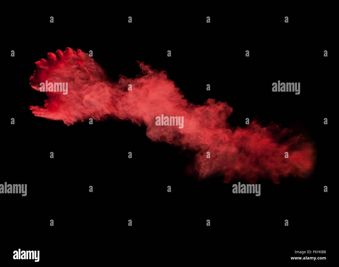 Freeze motion of red dust explosion on black background Stock Photo - Alamy