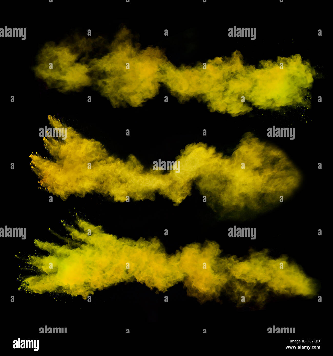 Freeze motion of yellow dust explosions on black background Stock Photo ...