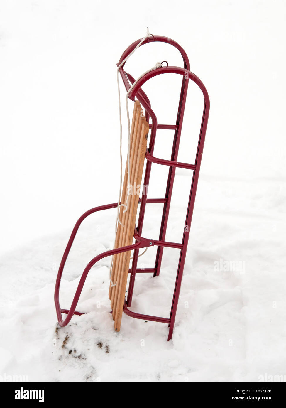 red sledge in the snow Stock Photo - Alamy
