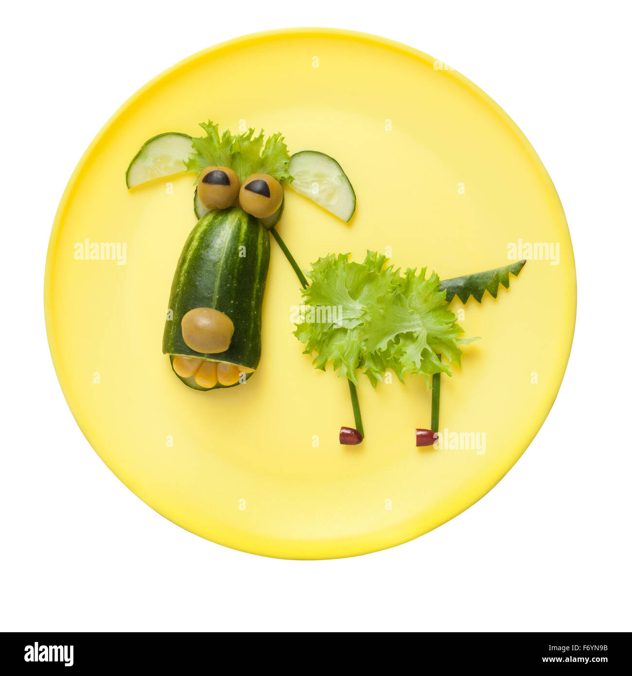 Funny vegetable dog on yellow plate Stock Photo - Alamy