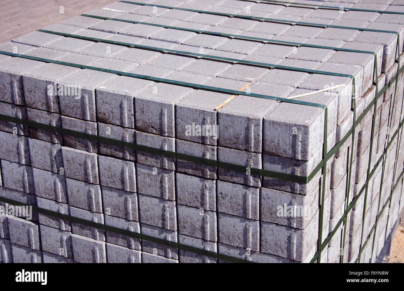 Stack of cement bricks tied with plastic Stock Photo - Alamy