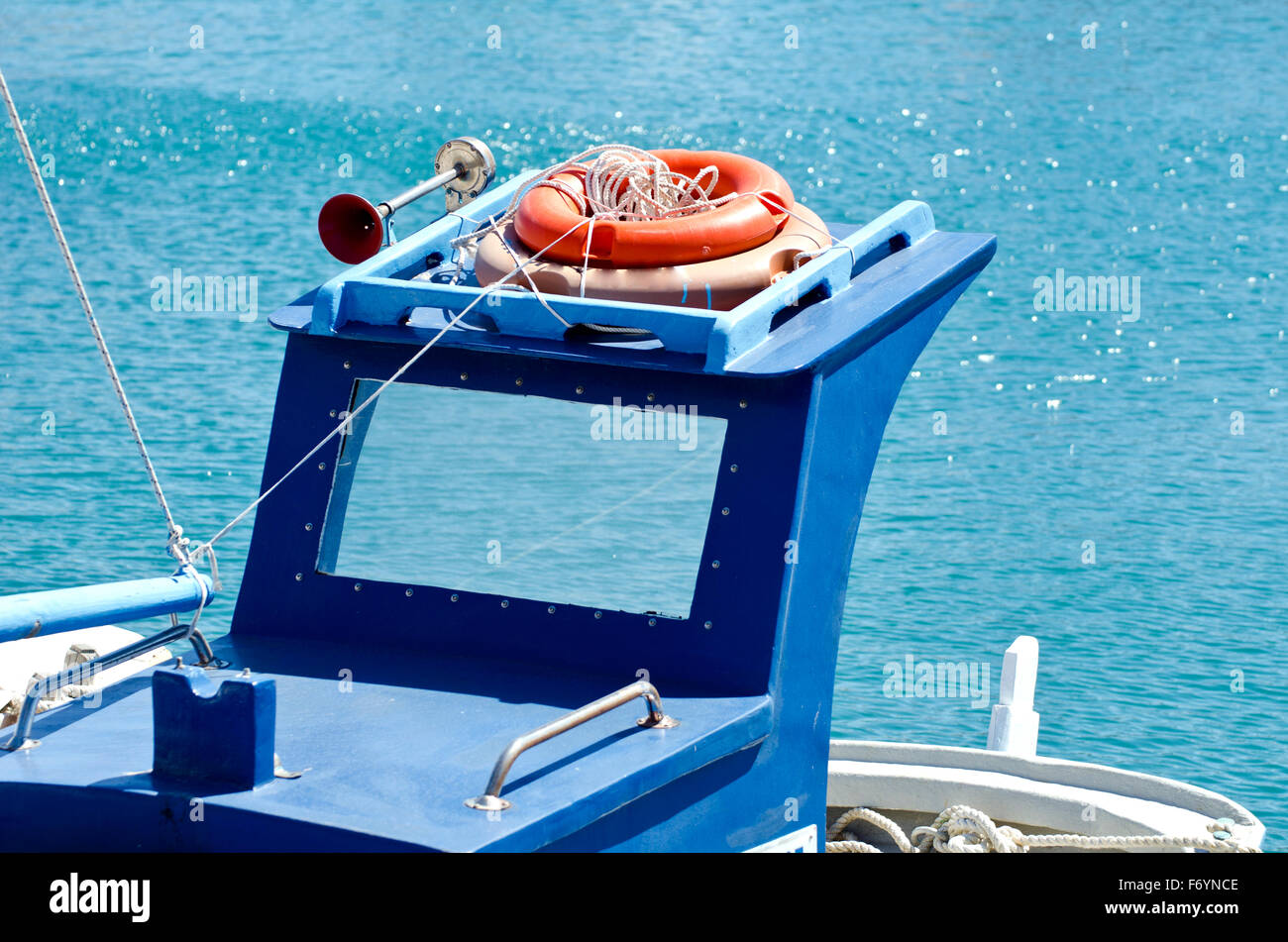Roof of a blue boat with orange lifebuoys in sea harbor Stock Photo - Alamy