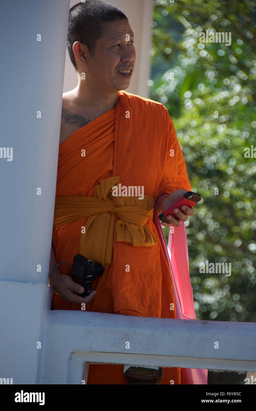 Thai monk using mobile phone and digital camera Stock Photo - Alamy