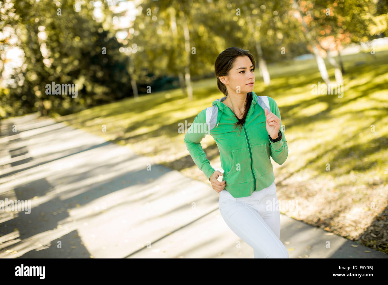 Young woman running in the park Stock Photo - Alamy