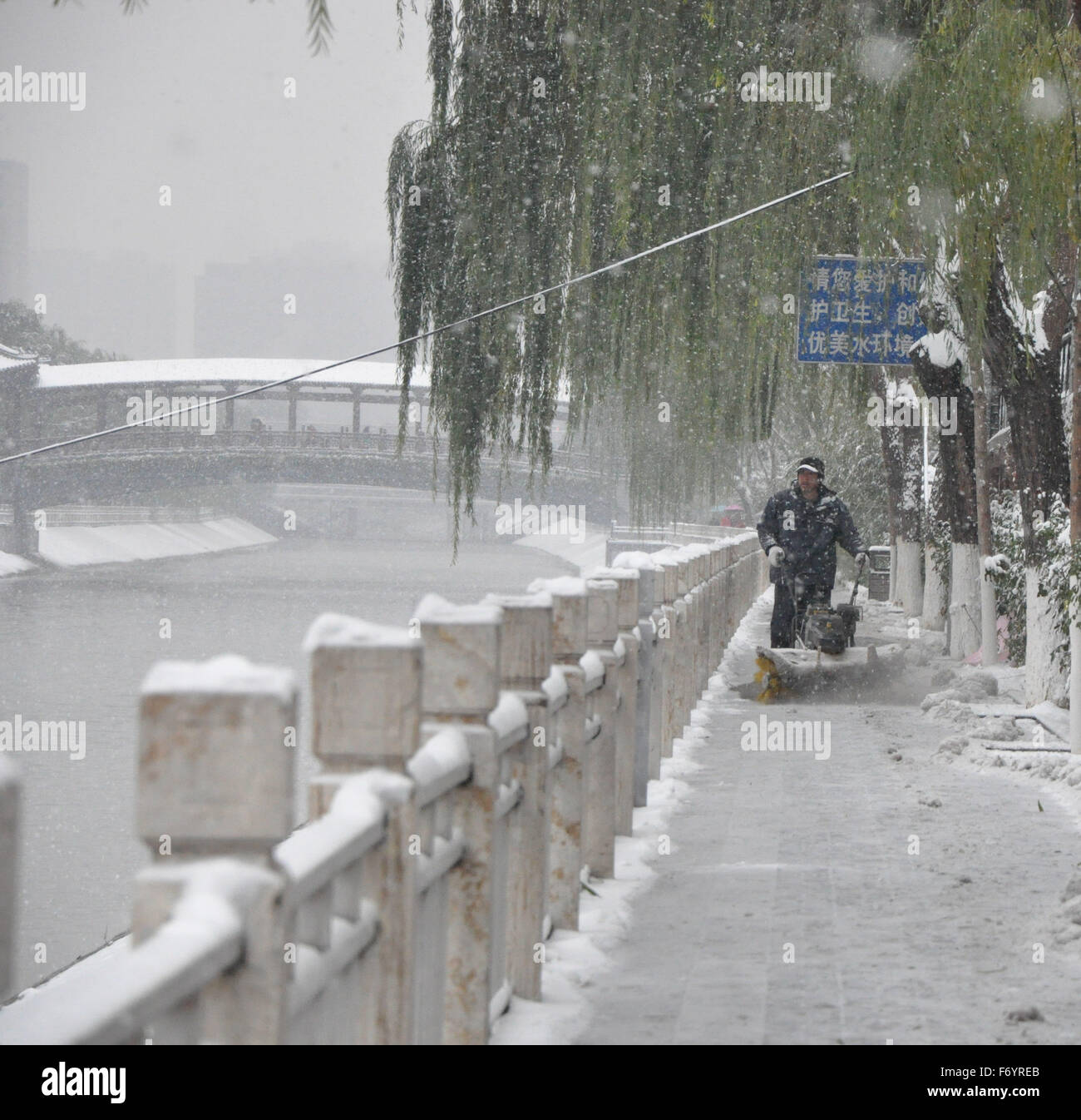 Beijing, China. 22nd Nov, 2015. A sanitation worker clears snow off ...