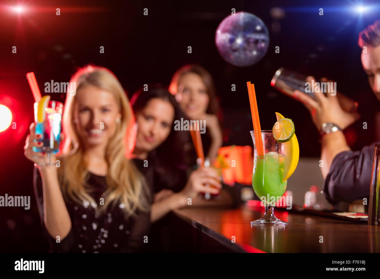 Young friends drinking cocktails together at party Stock Photo - Alamy