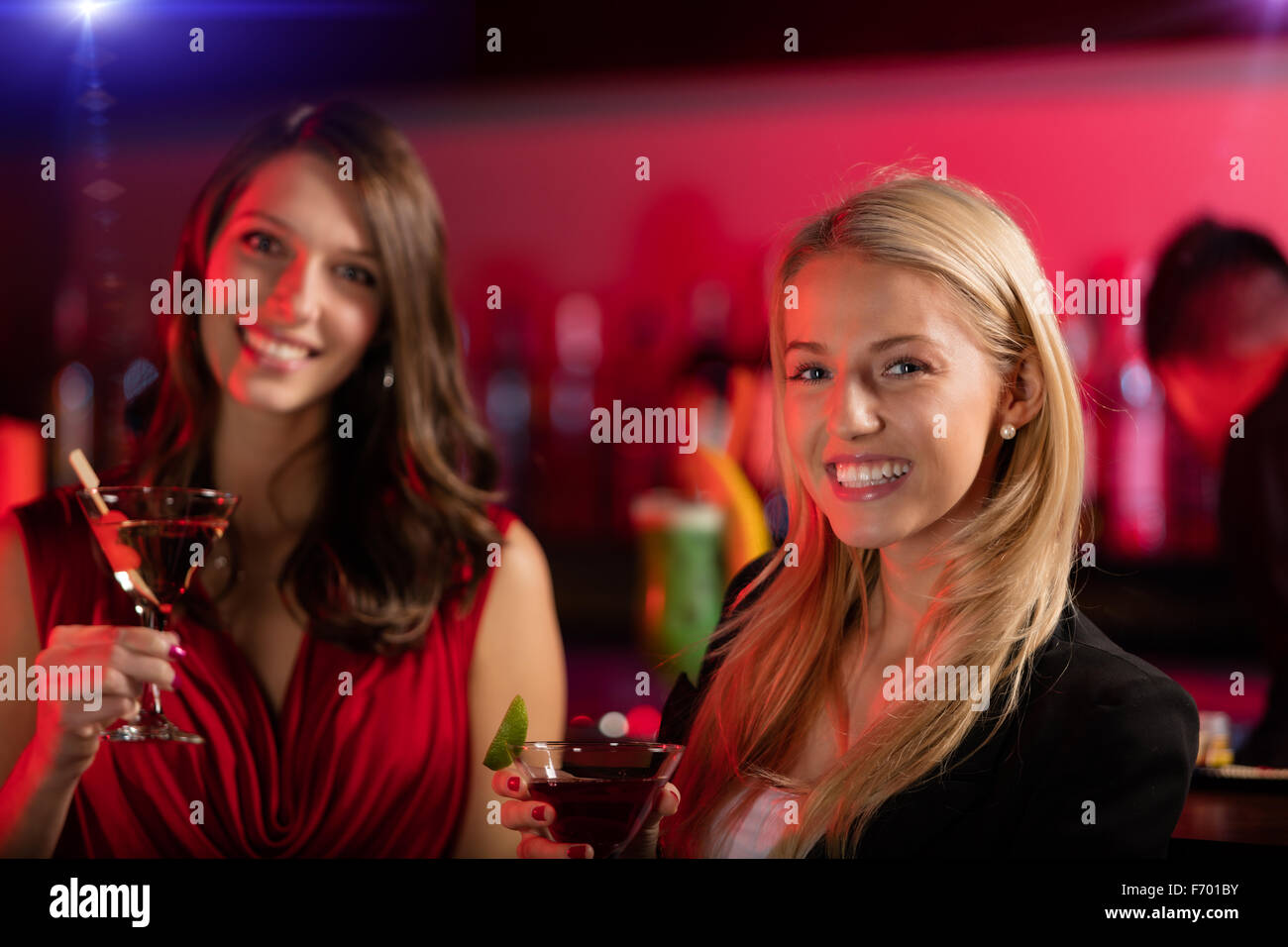Two girls at the bar with cocktail drink Stock Photo - Alamy