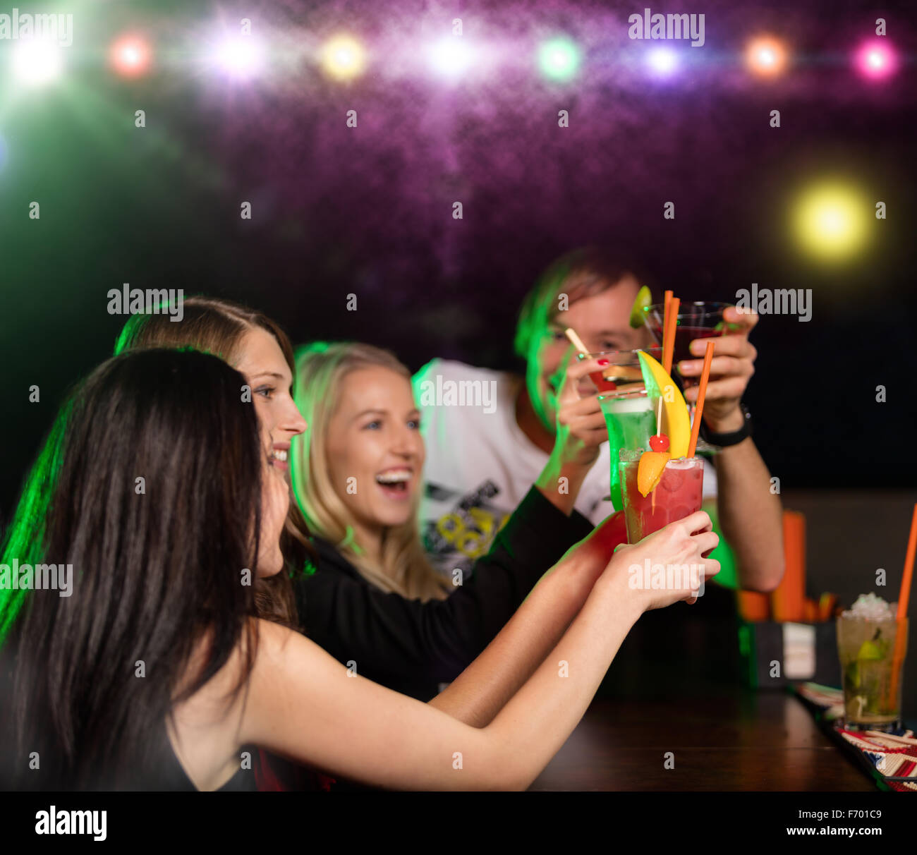Young friends drinking cocktails together at party Stock Photo - Alamy